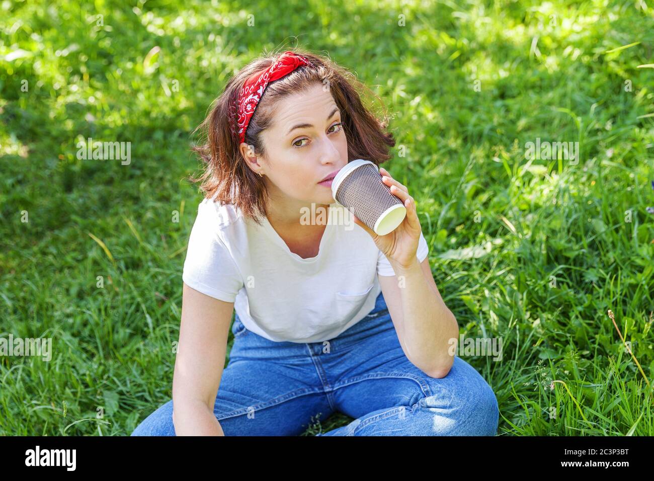 Happy girl smiling outdoor having lunch break. Beautiful young brunete ...