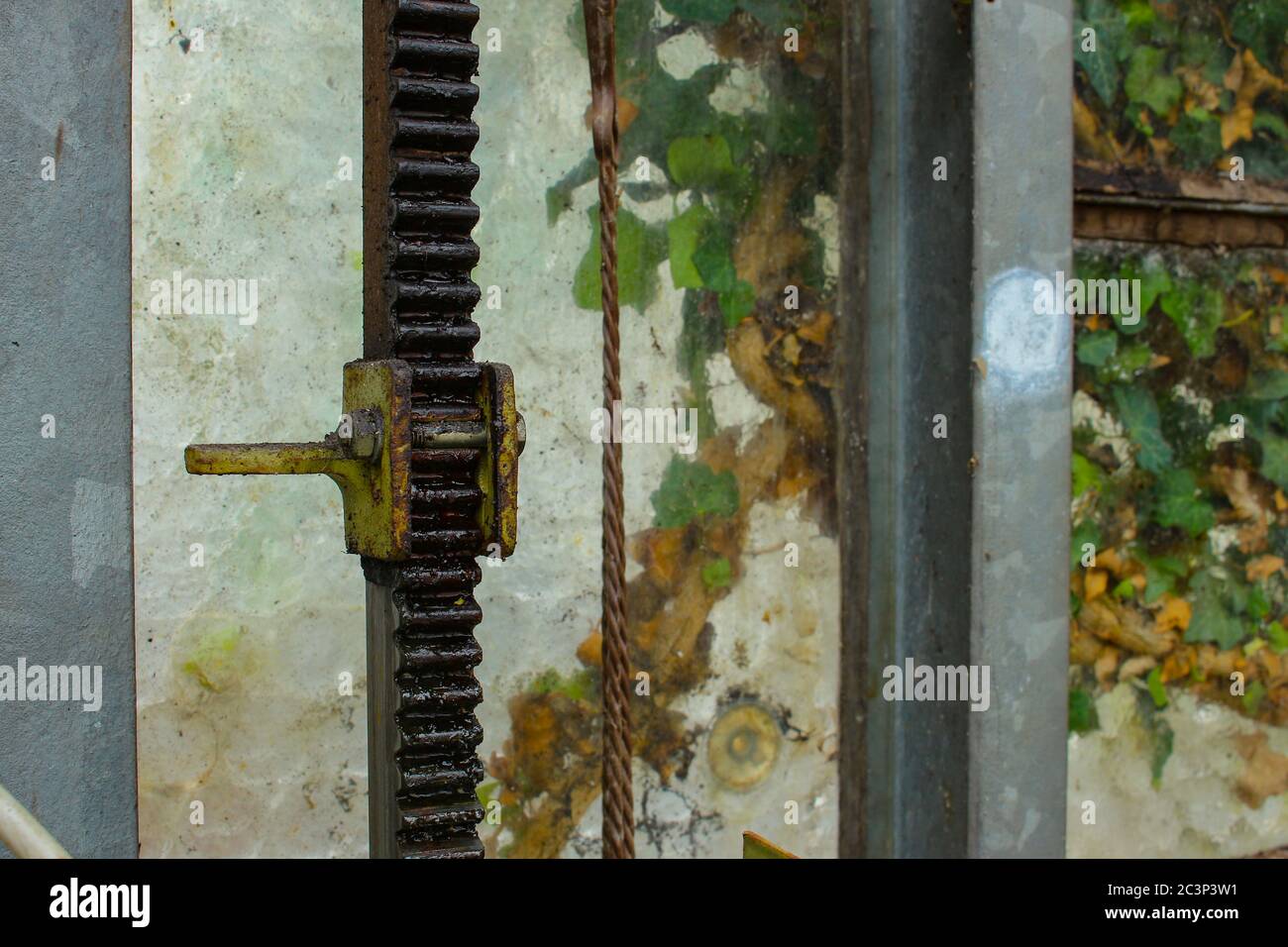 Close up of a old and rusty straight tooth rack covered with grease ...