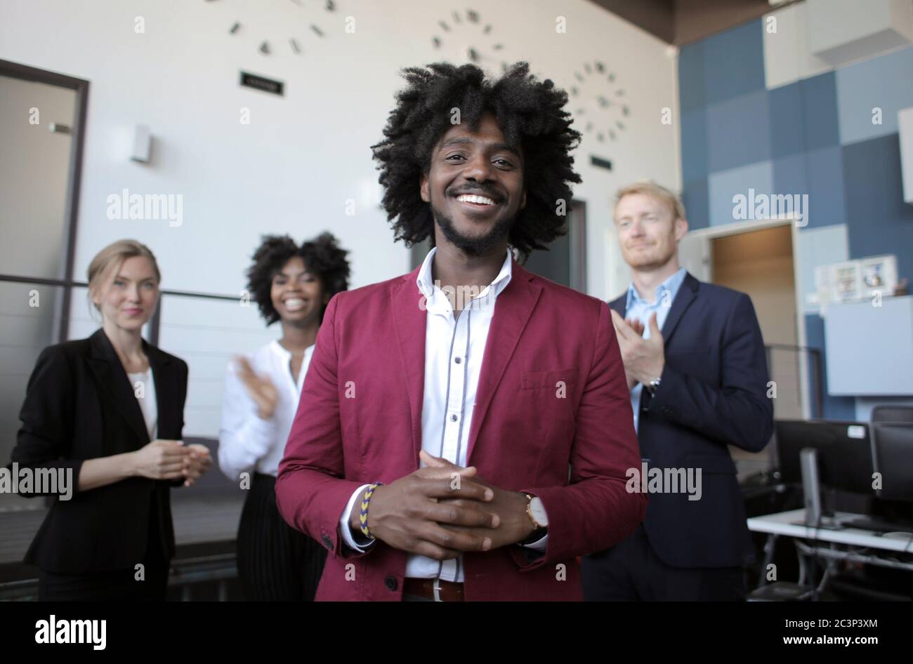 View of an African-American male getting a promotion at the workplace ...