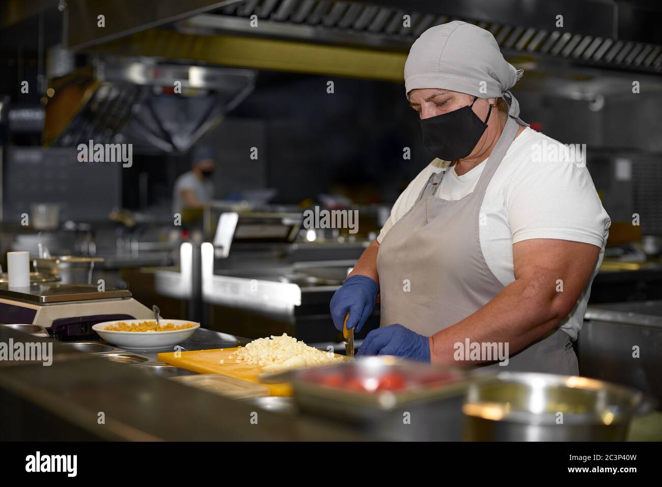 cooking, profession and people concept - woman in age chef wearing ...