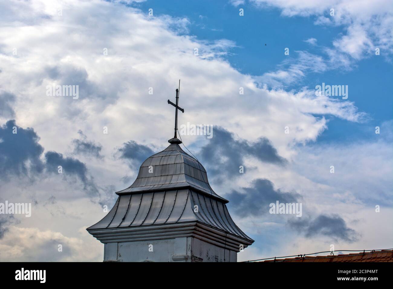 Church top covered with tin and cross on top. There is also a lightning ...