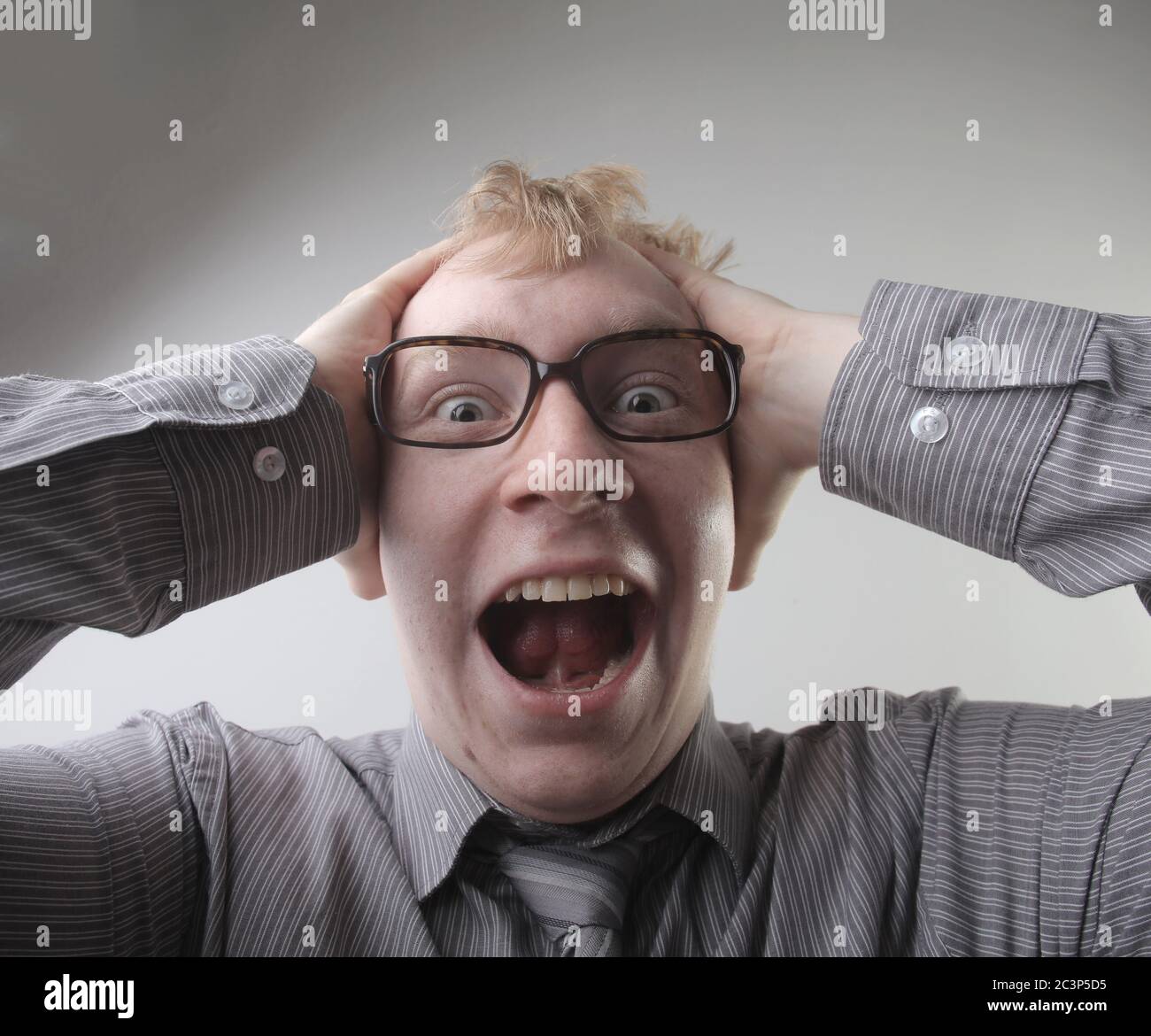 View of a male wearing a grey shirt with a happy and excited facial ...