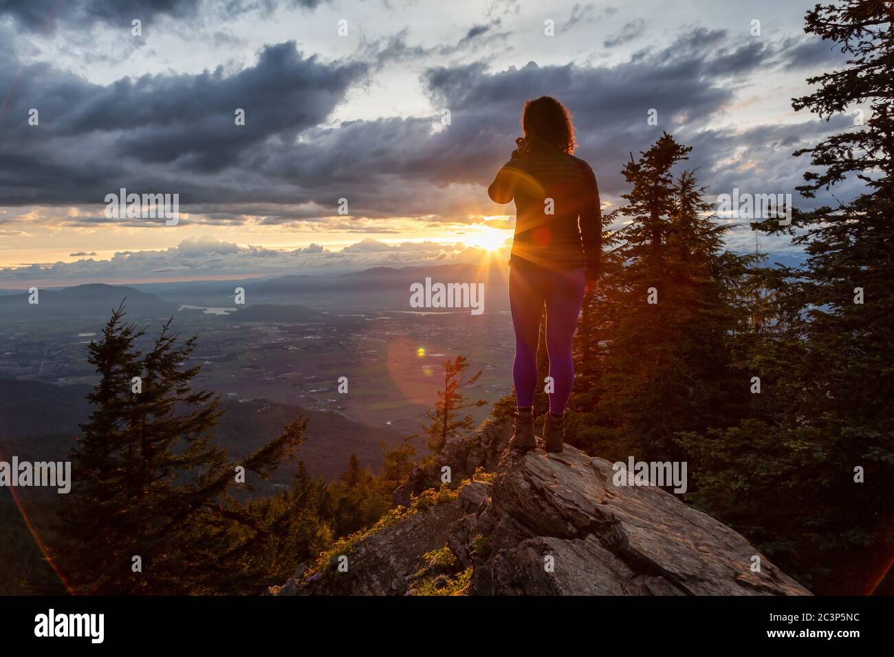 Fantasy Adventure Composite with a Man on top of a Mountain Cliff Stock ...