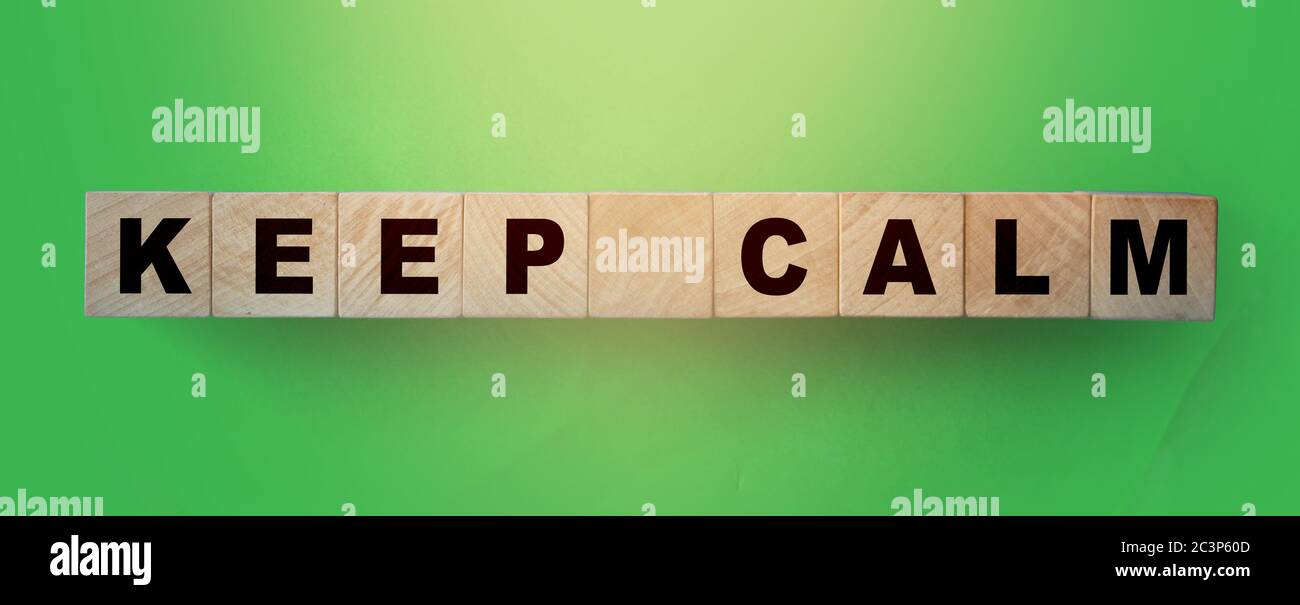 KEEP CALM word on wooden blocks on green gradient background. No panic ...