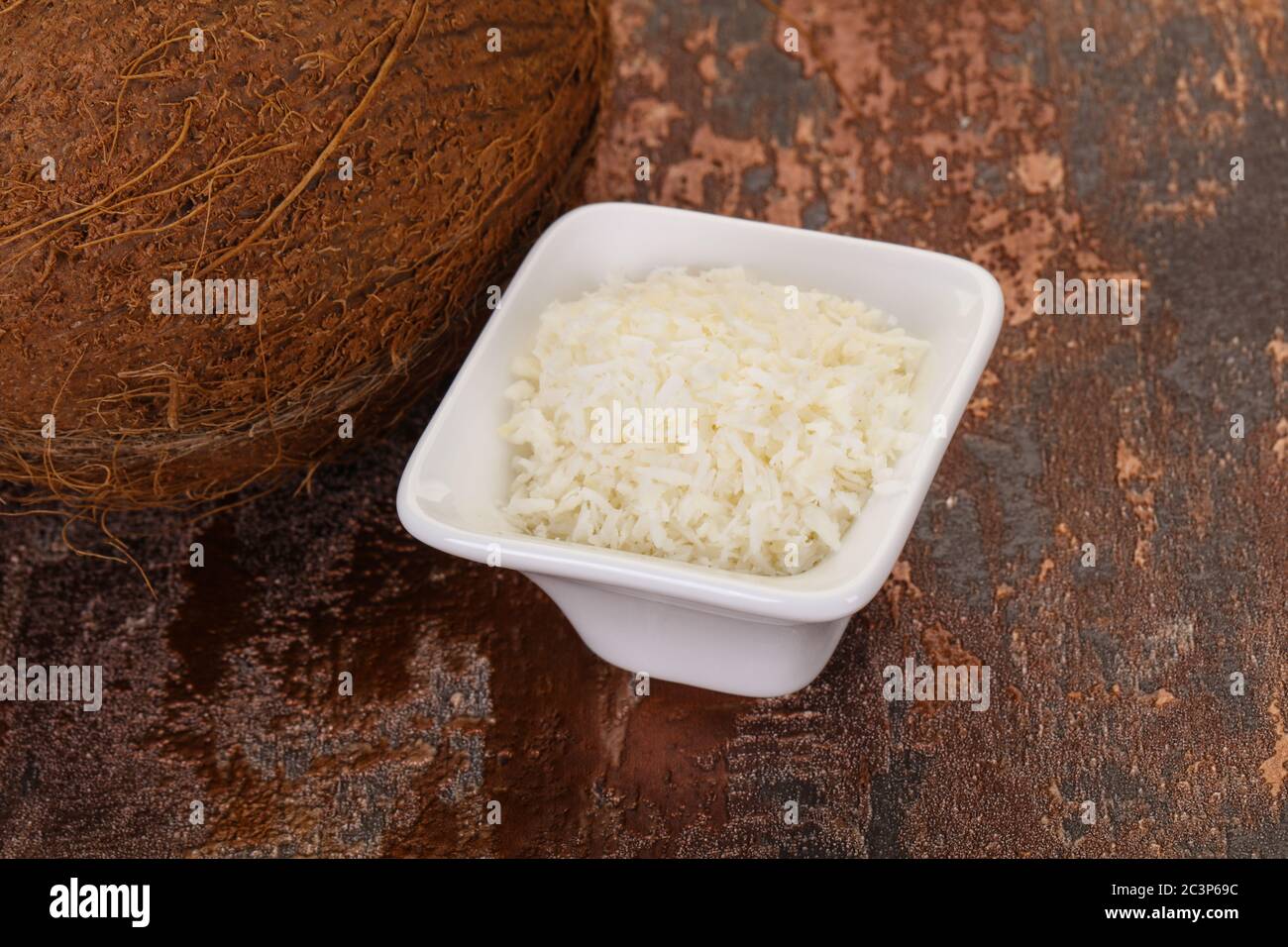 Coconut shredded chip with nut over wooden background Stock Photo - Alamy