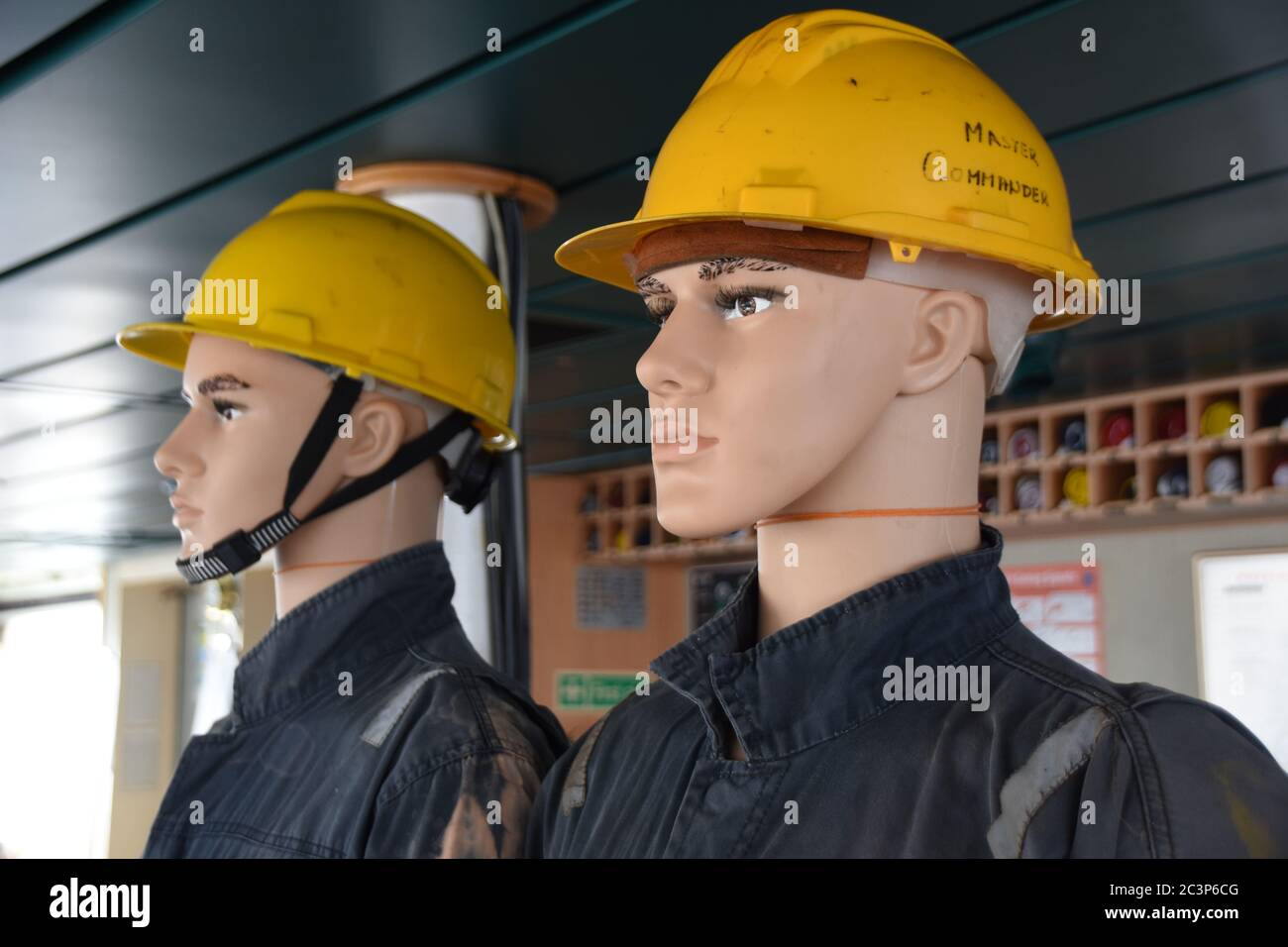Two dummies in helmets ready to be exposed on the bridge of container ...