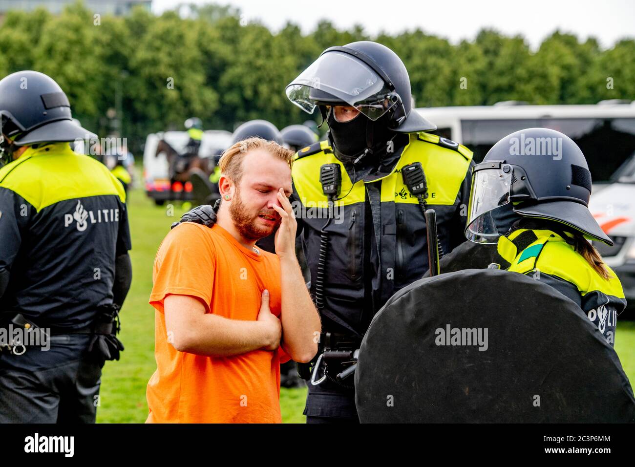 Police officer comforting a crying man during the demonstration ...