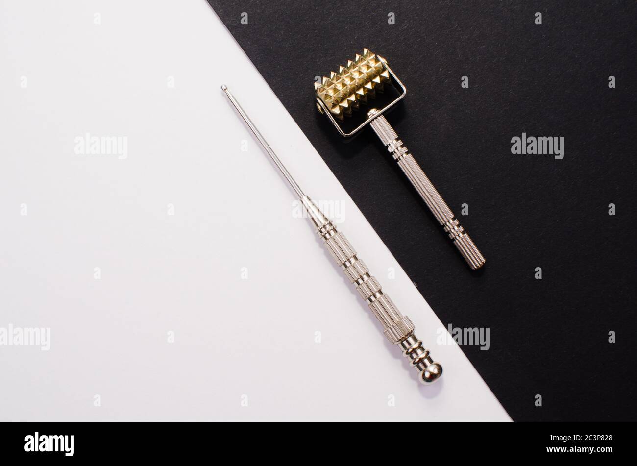 Black and white background. Acupuncture roller and stylus ...