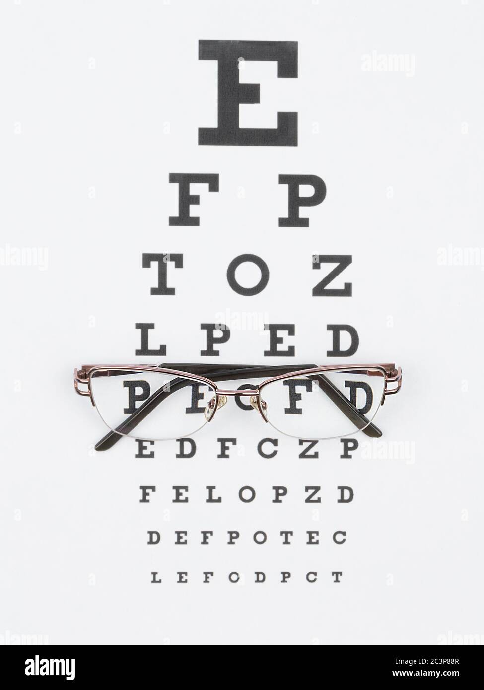 Glasses and optician chart on a white background Stock Photo - Alamy