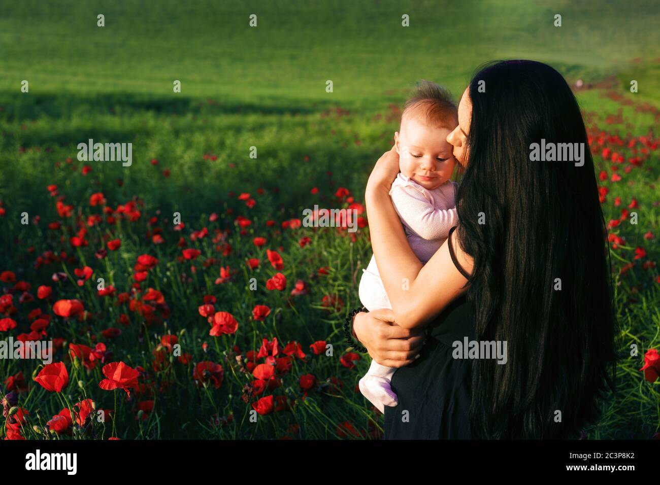 girl with a child in a poppy field, happy motherhood concept Stock ...