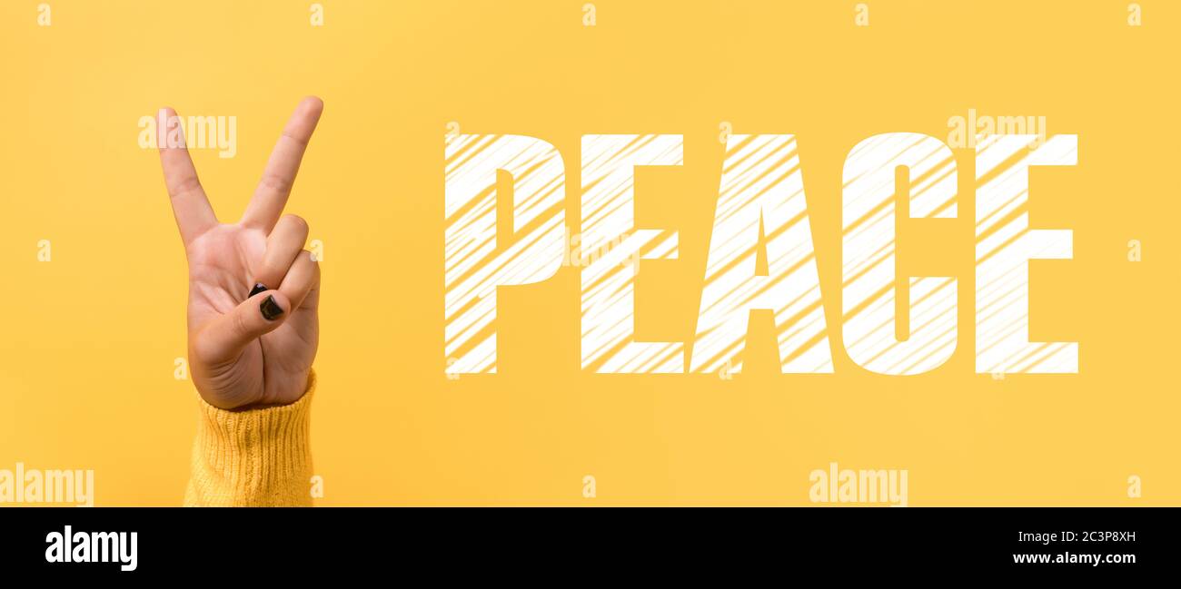 Hand gesture V sign for victory or peace sign over yellow background ...