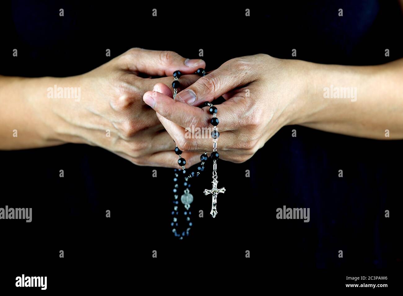 Womans hands holding rosary hi-res stock photography and images - Alamy