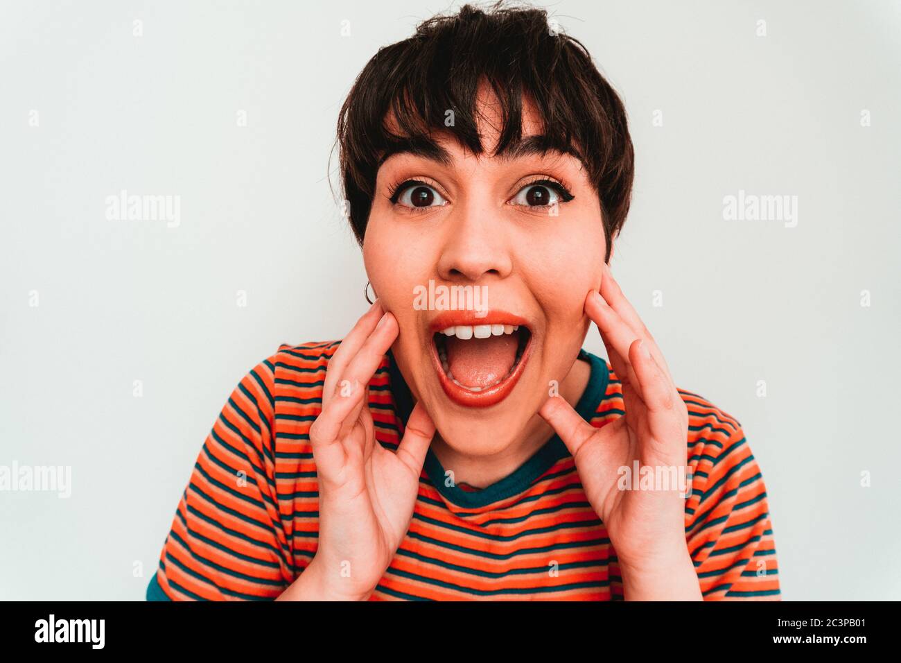 Self-portrait of a caucasian female with an exciting facial expression ...