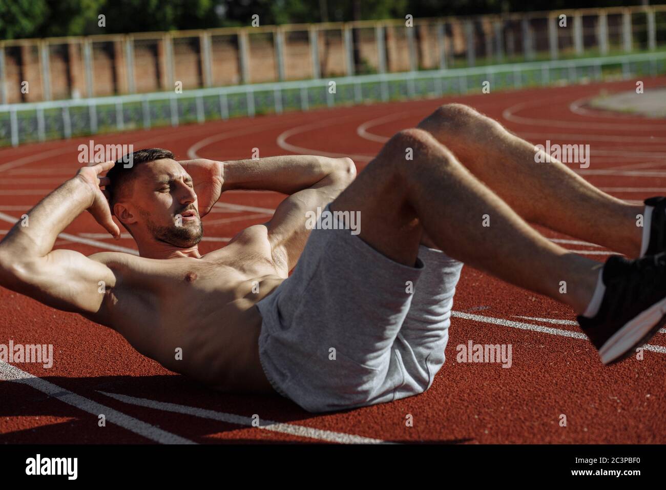 Shirtless muscular man doing abs workout outside. Sportsman. Strong man ...