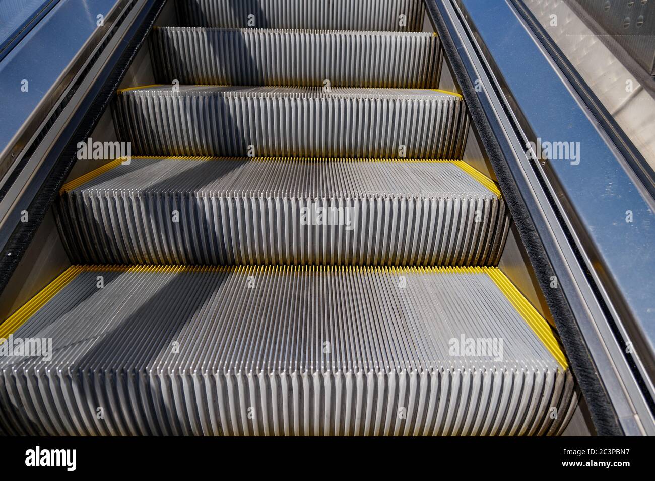 Sunny and outdoor top view from eye level riser and tread of escalator ...