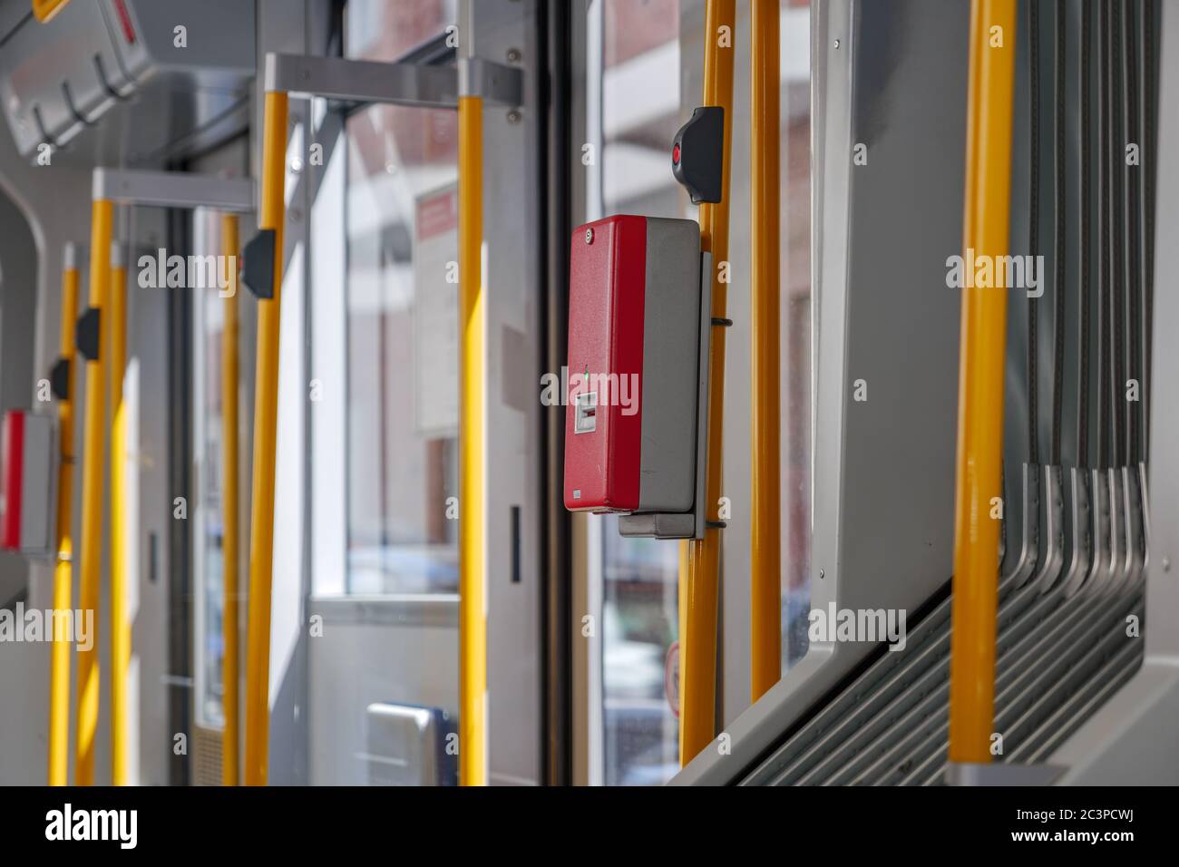 Red public transportation ticket stamp or validation ticket machine in ...