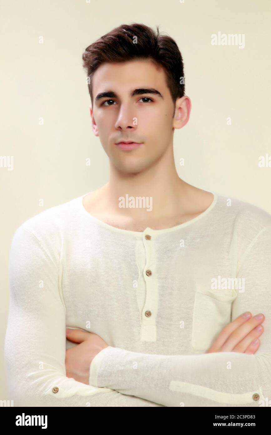 Attractive male model with short hair posing in studio on isolated ...