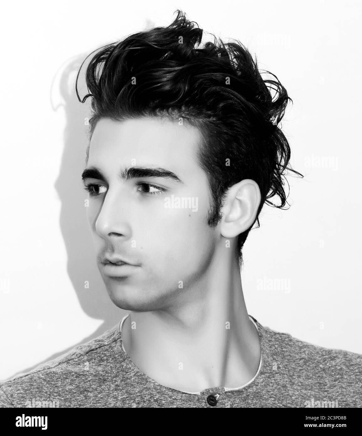Attractive male model with short hair posing in studio on isolated ...