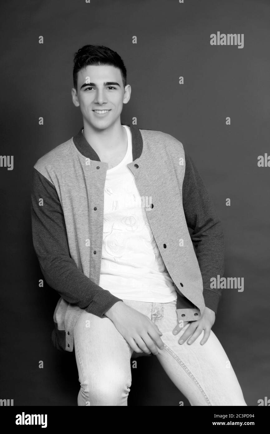 Attractive male model with short hair posing in studio on isolated ...