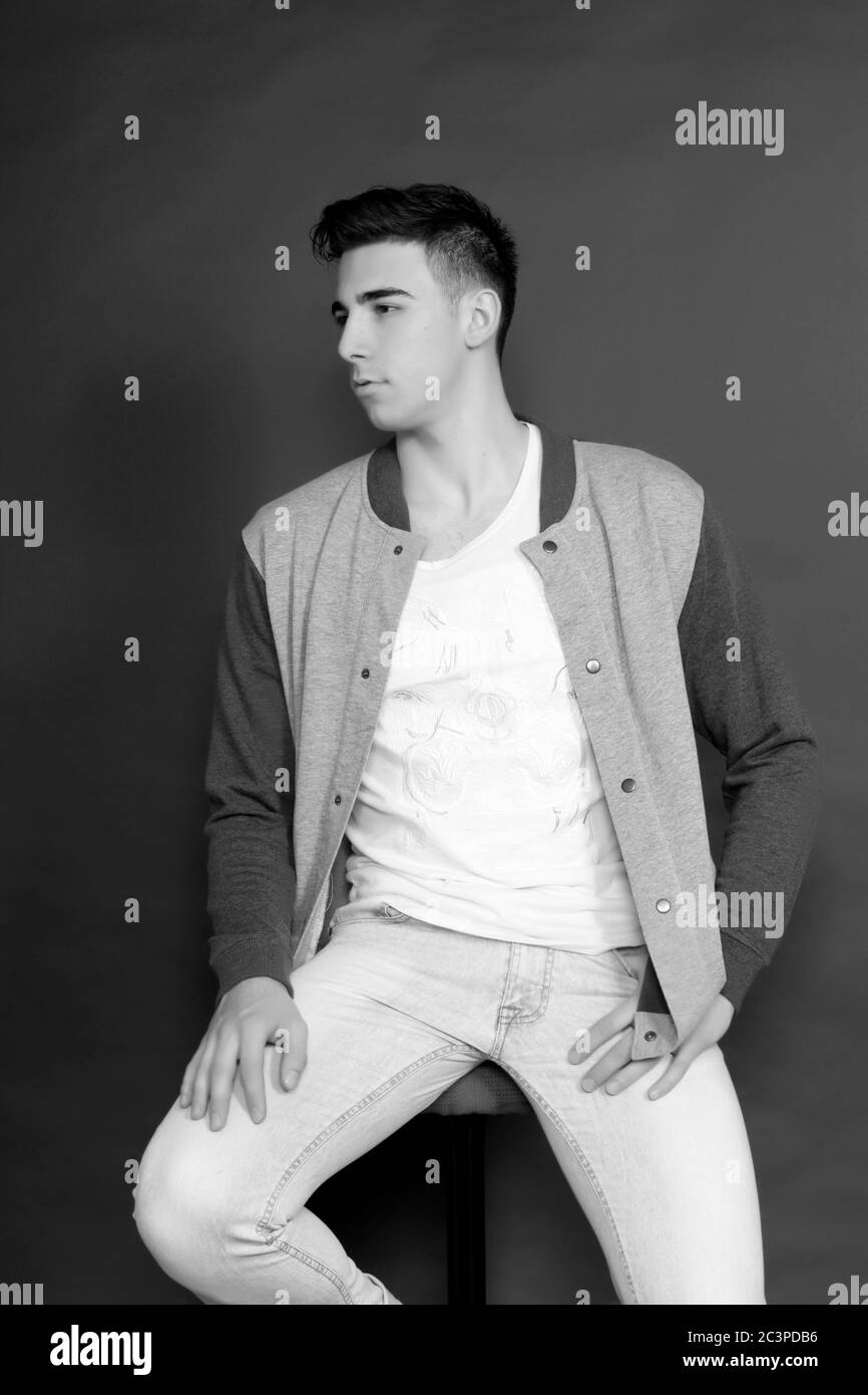 Attractive male model with short hair posing in studio on isolated ...