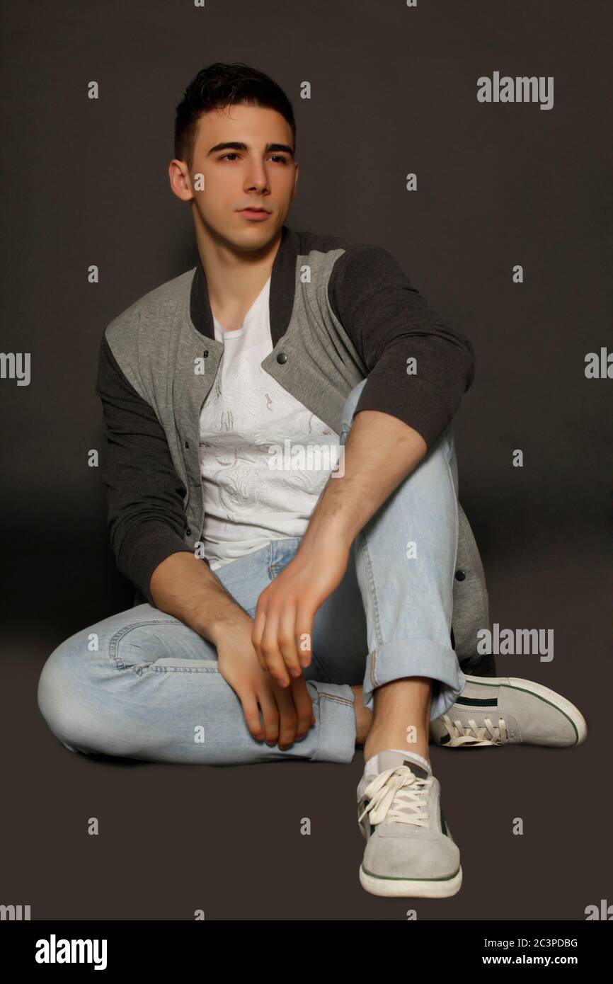 Attractive male model with short hair posing in studio on isolated ...