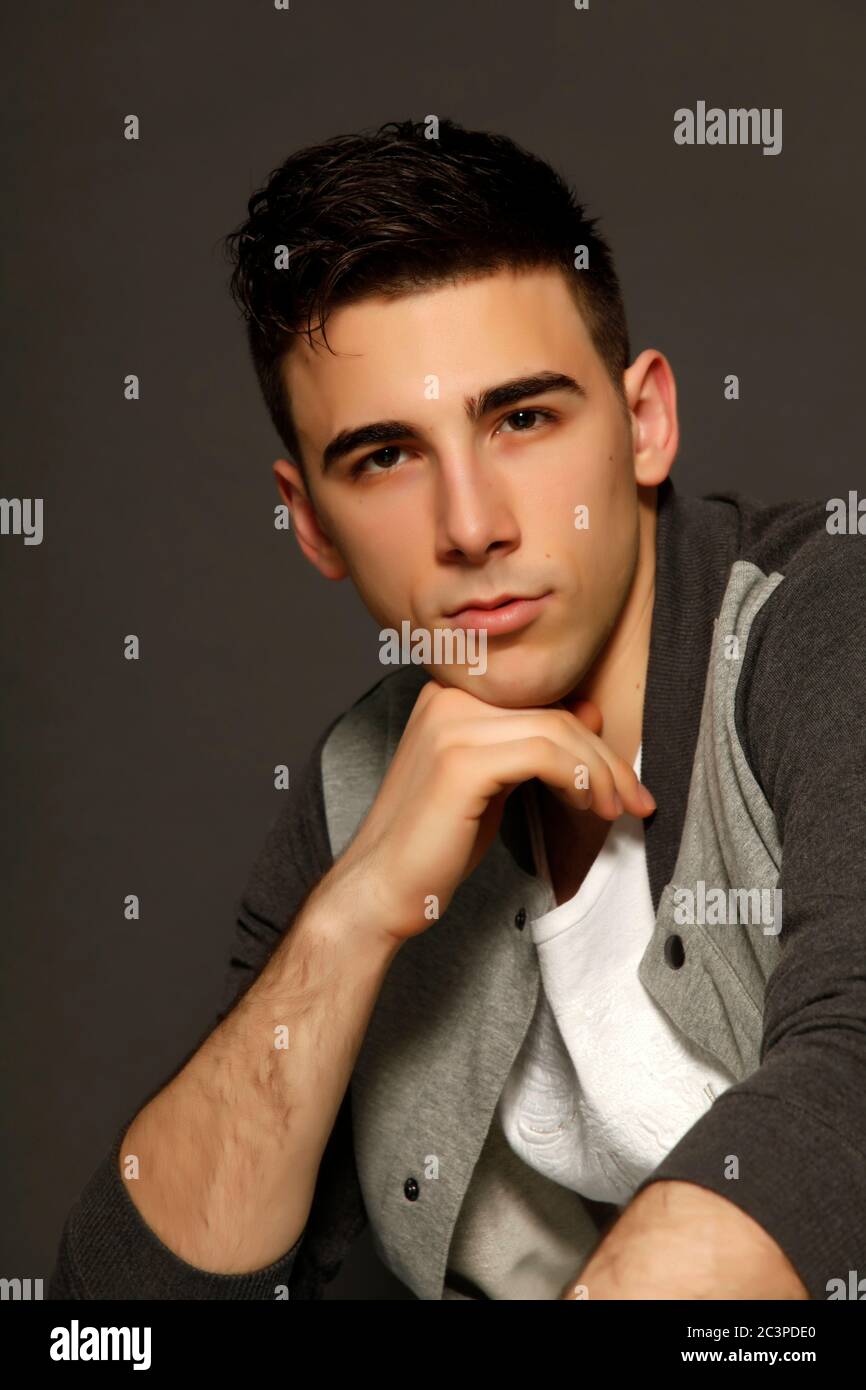 Attractive male model with short hair posing in studio on isolated ...