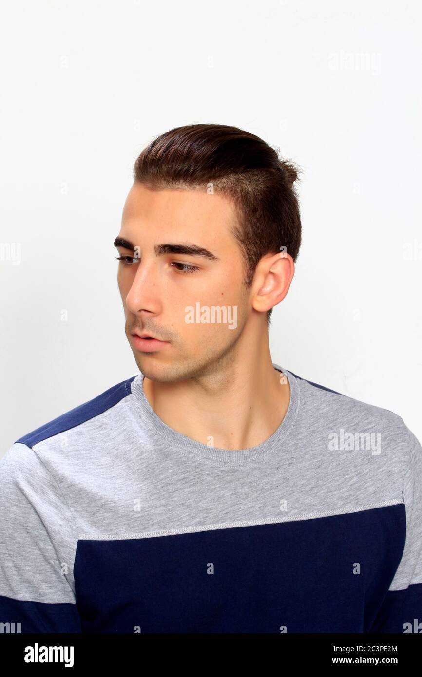 Attractive male model with short hair posing in studio on isolated ...