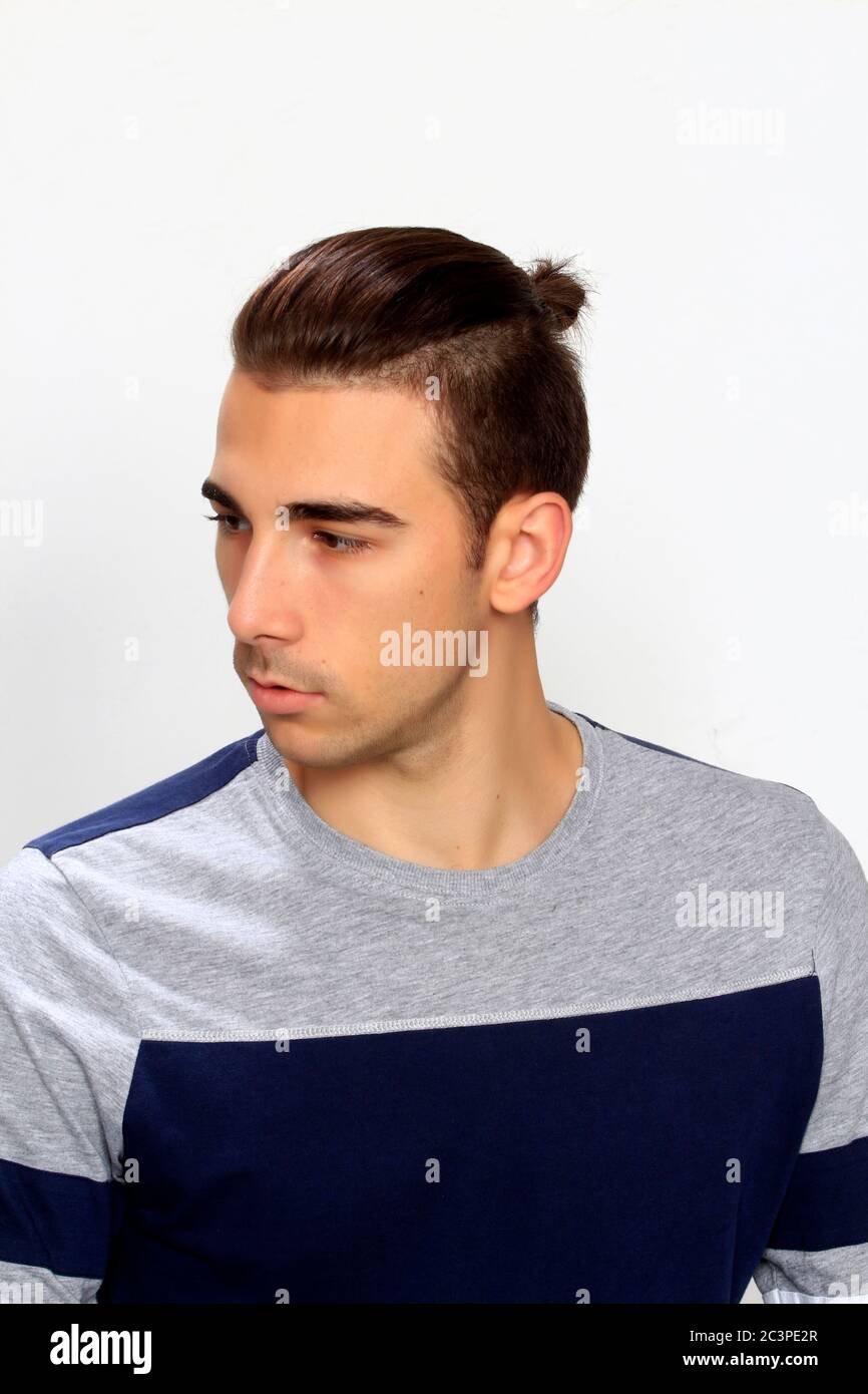 Attractive male model with short hair posing in studio on isolated ...