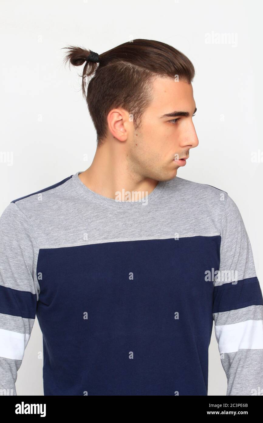 Attractive male model with short hair posing in studio on isolated ...