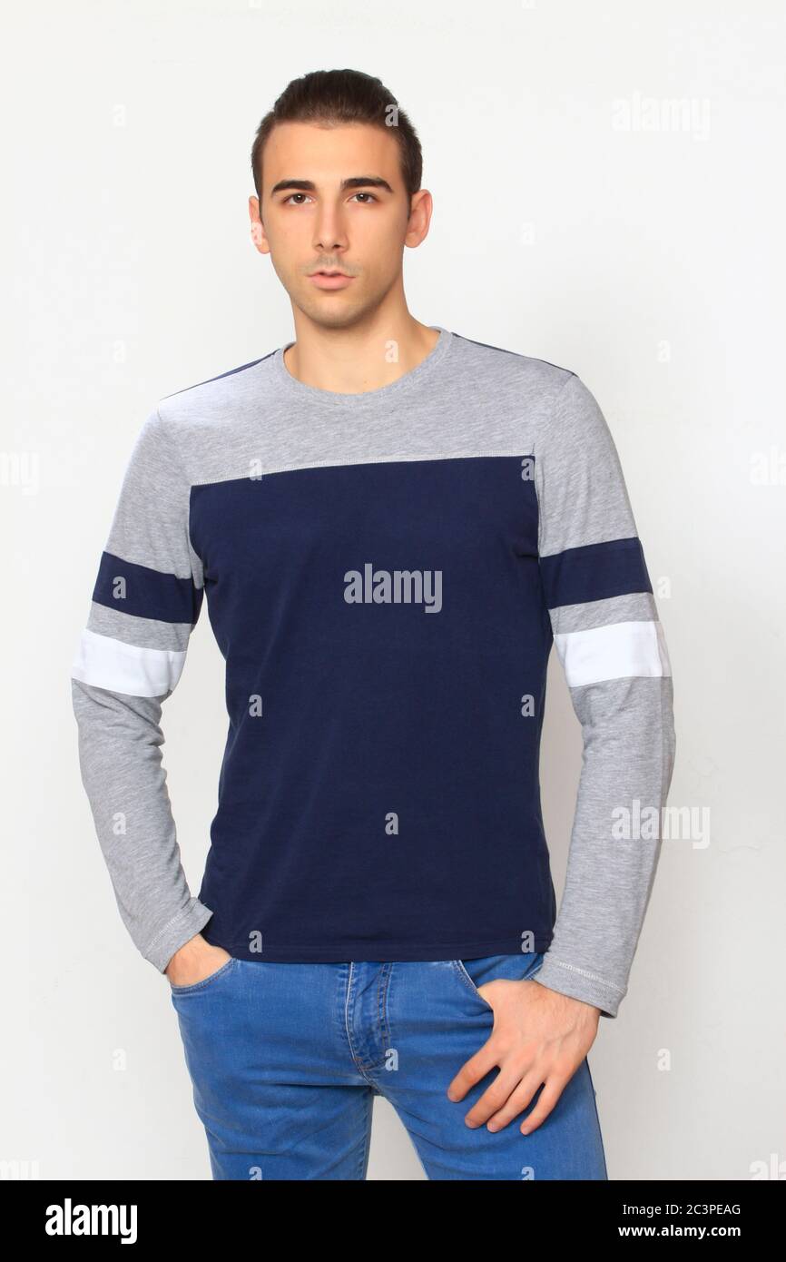 Attractive male model with short hair posing in studio on isolated ...