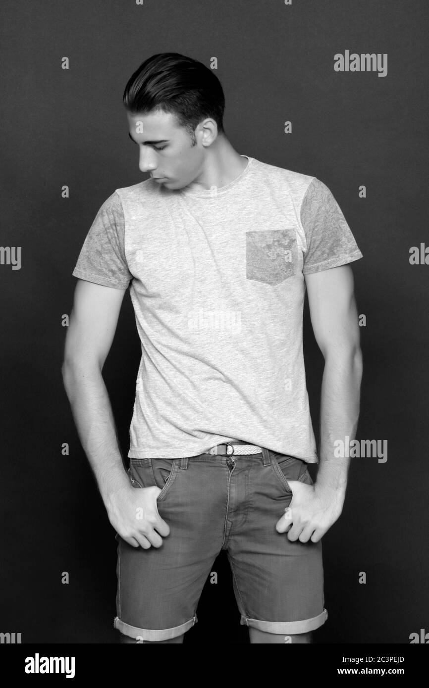 Attractive male model with short hair posing in studio on isolated ...