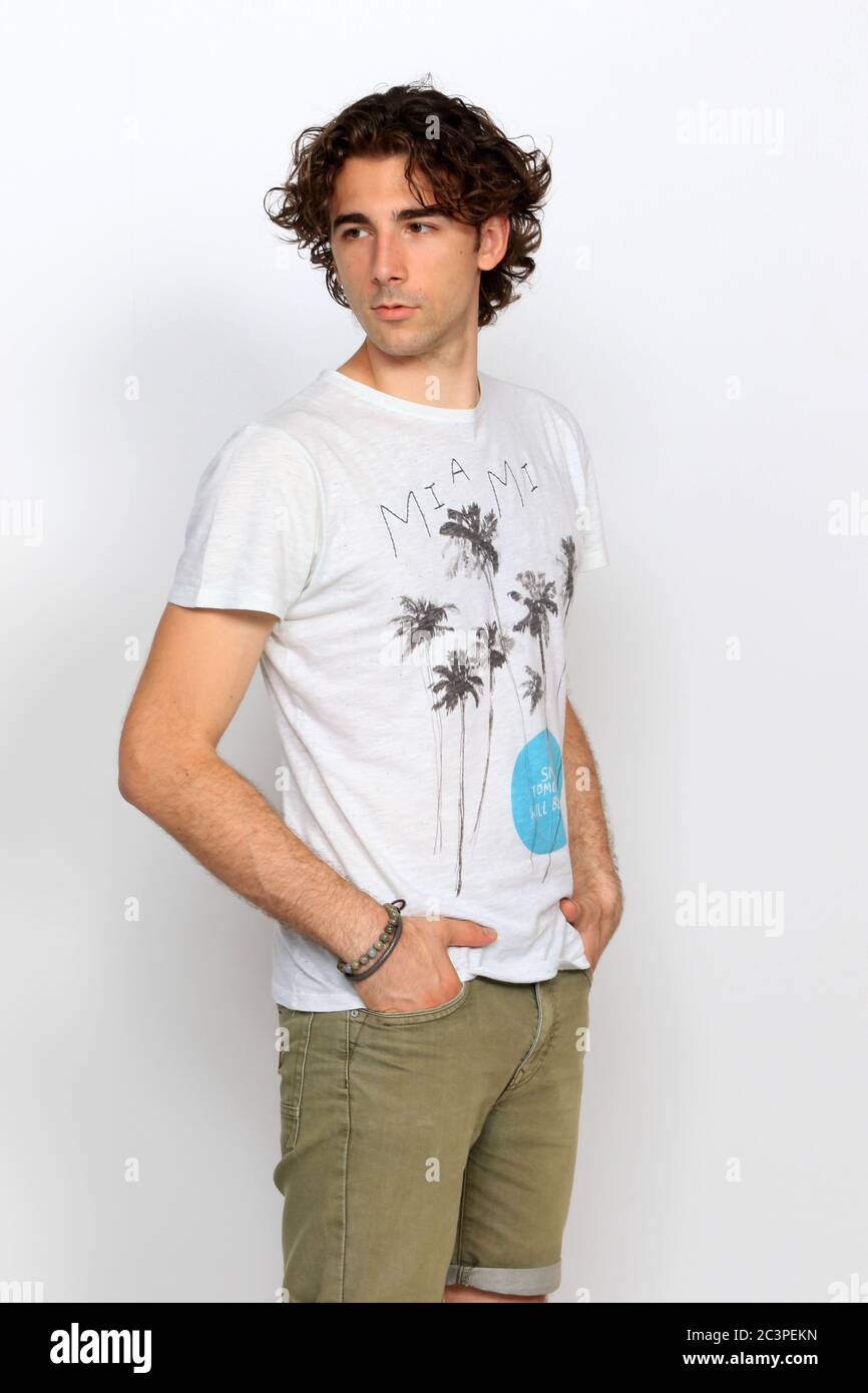 Attractive male model with short hair posing in studio on isolated ...