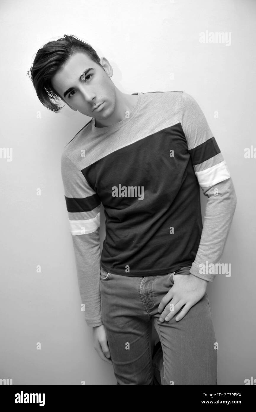 Attractive male model with short hair posing in studio on isolated ...