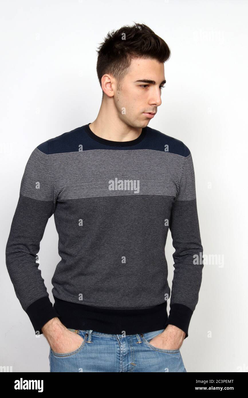 Attractive male model with short hair posing in studio on isolated ...