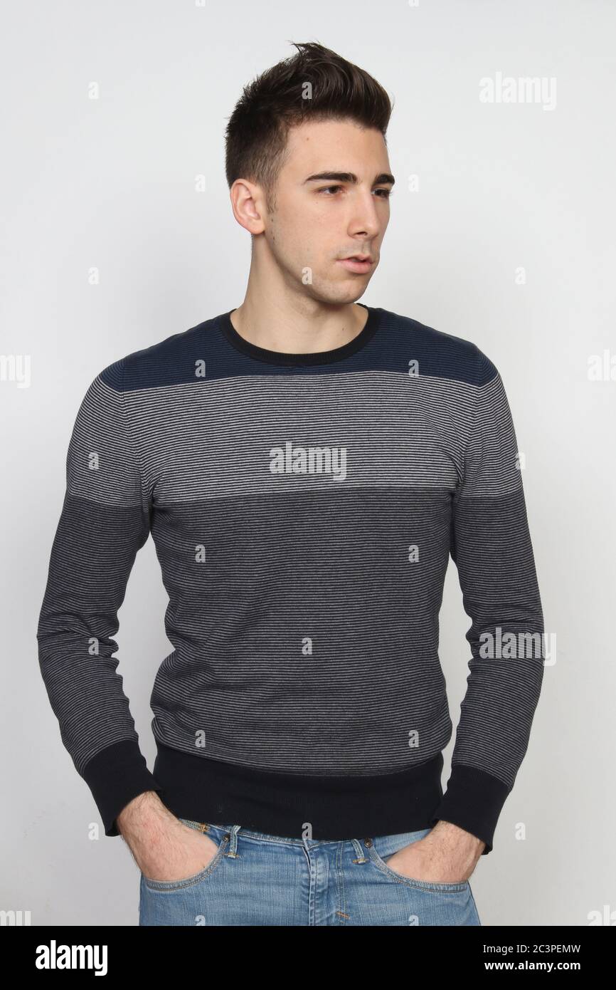 Attractive male model with short hair posing in studio on isolated ...