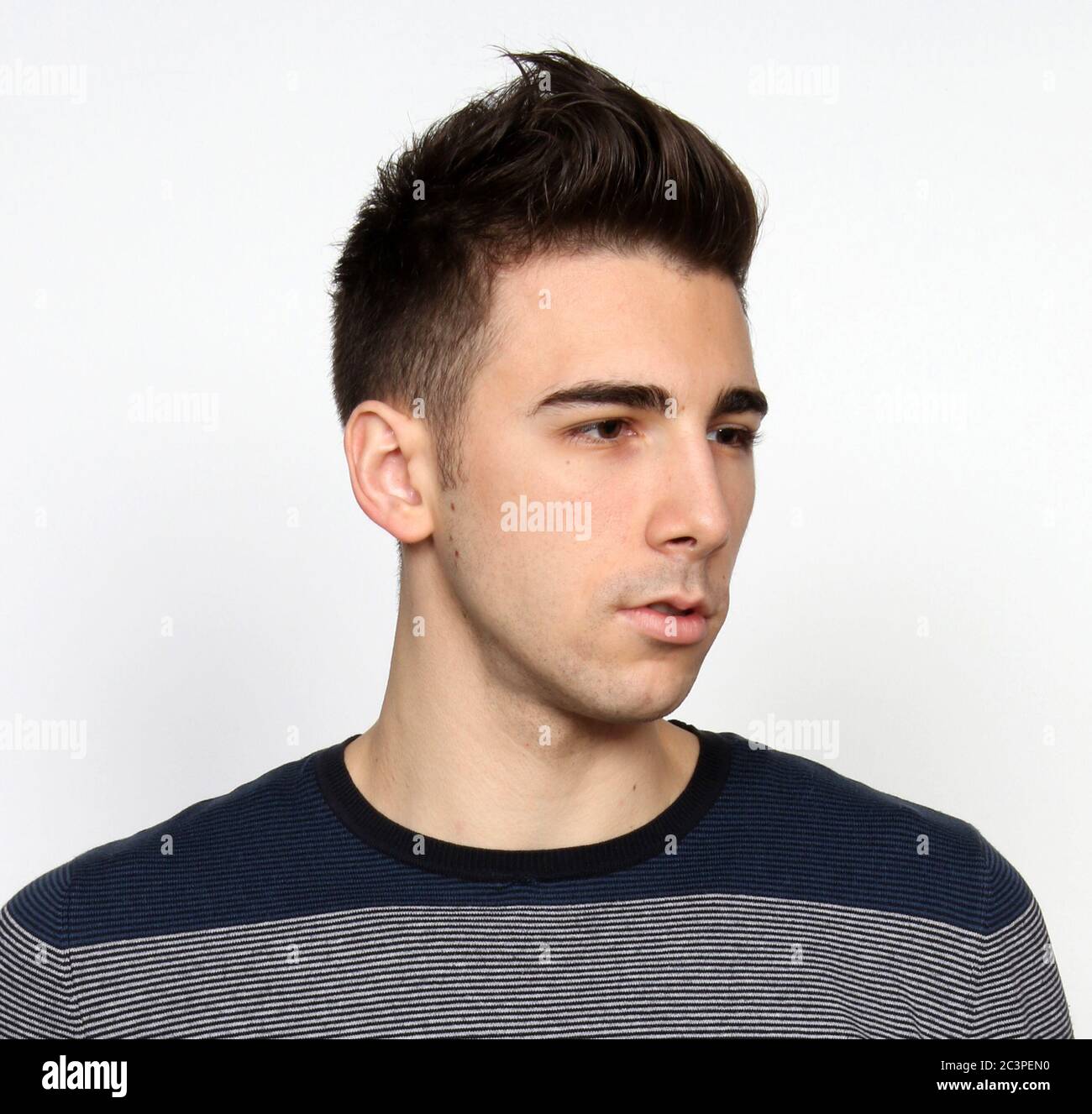 Attractive male model with short hair posing in studio on isolated ...