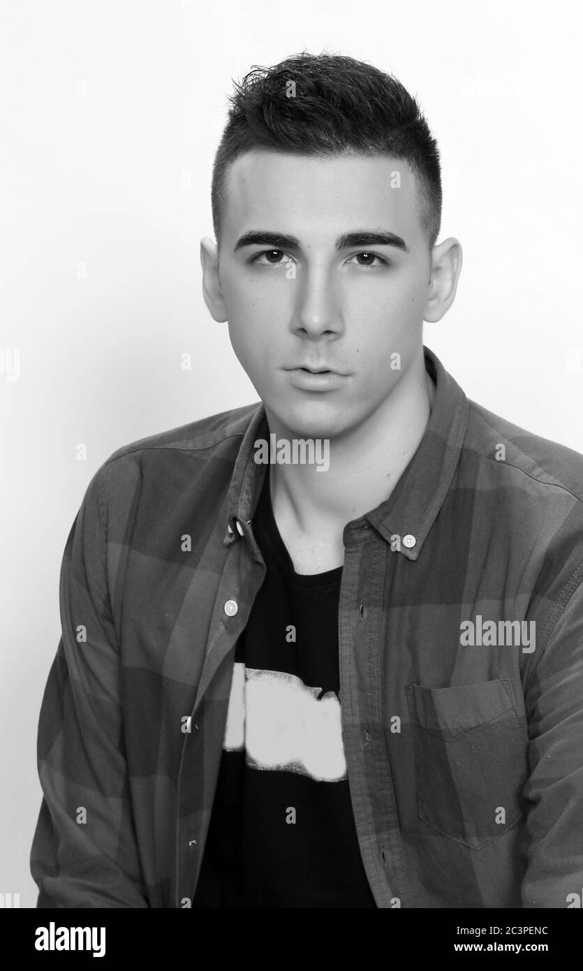 Attractive male model with short hair posing in studio on isolated ...