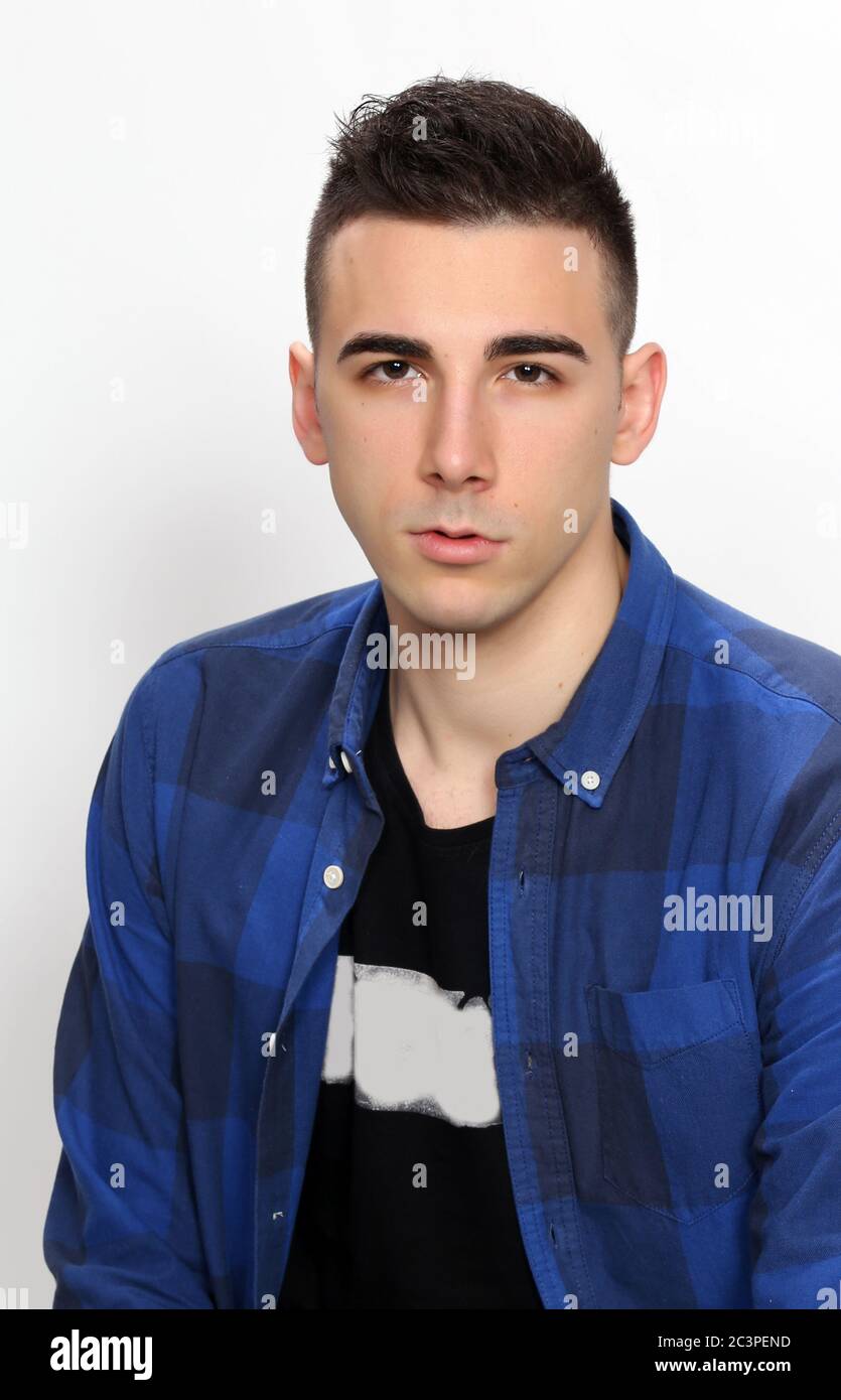 Attractive male model with short hair posing in studio on isolated ...