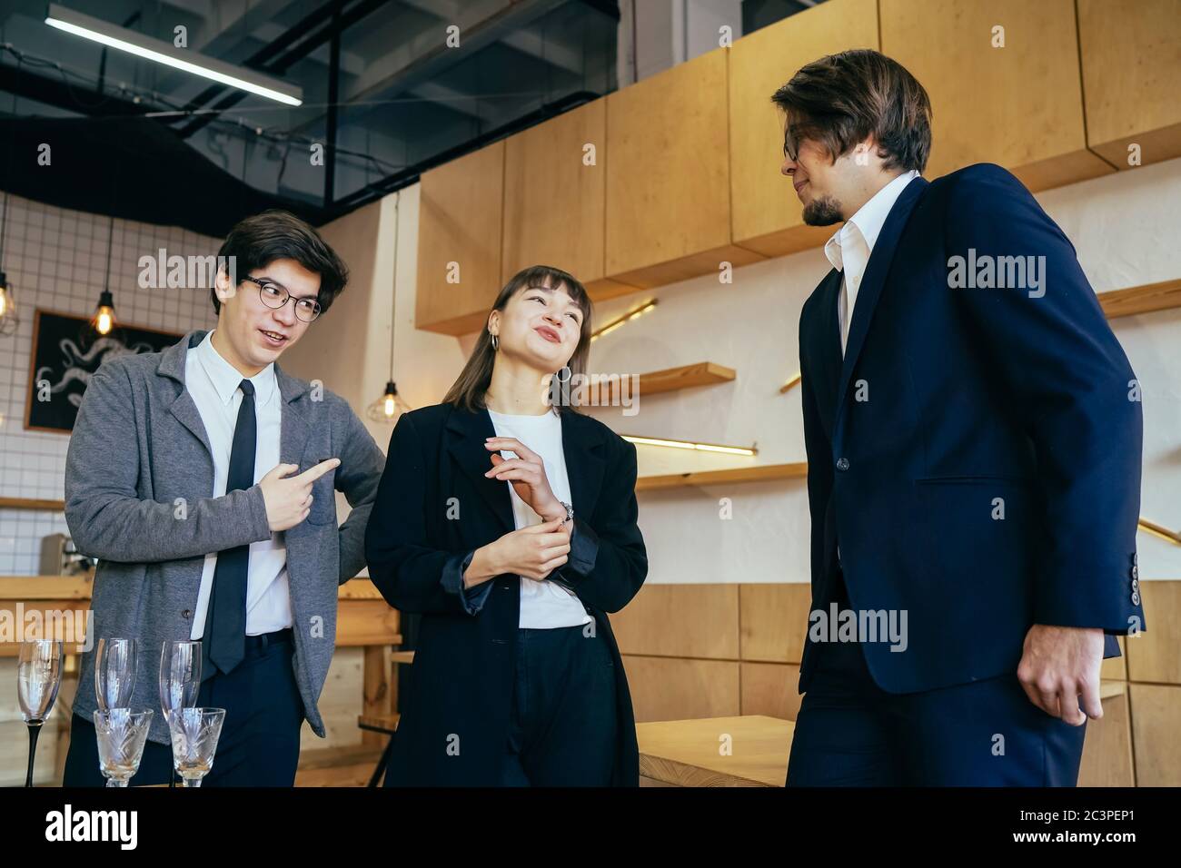 Group of business people in a meeting standing grouped in a office ...