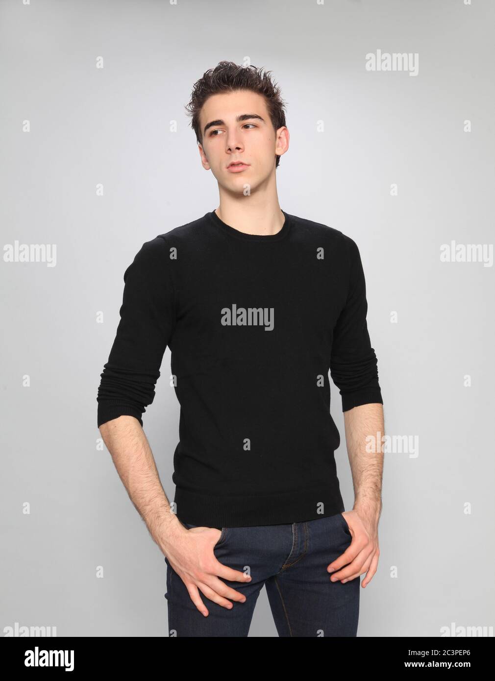 Attractive male model with short hair posing in studio on isolated ...