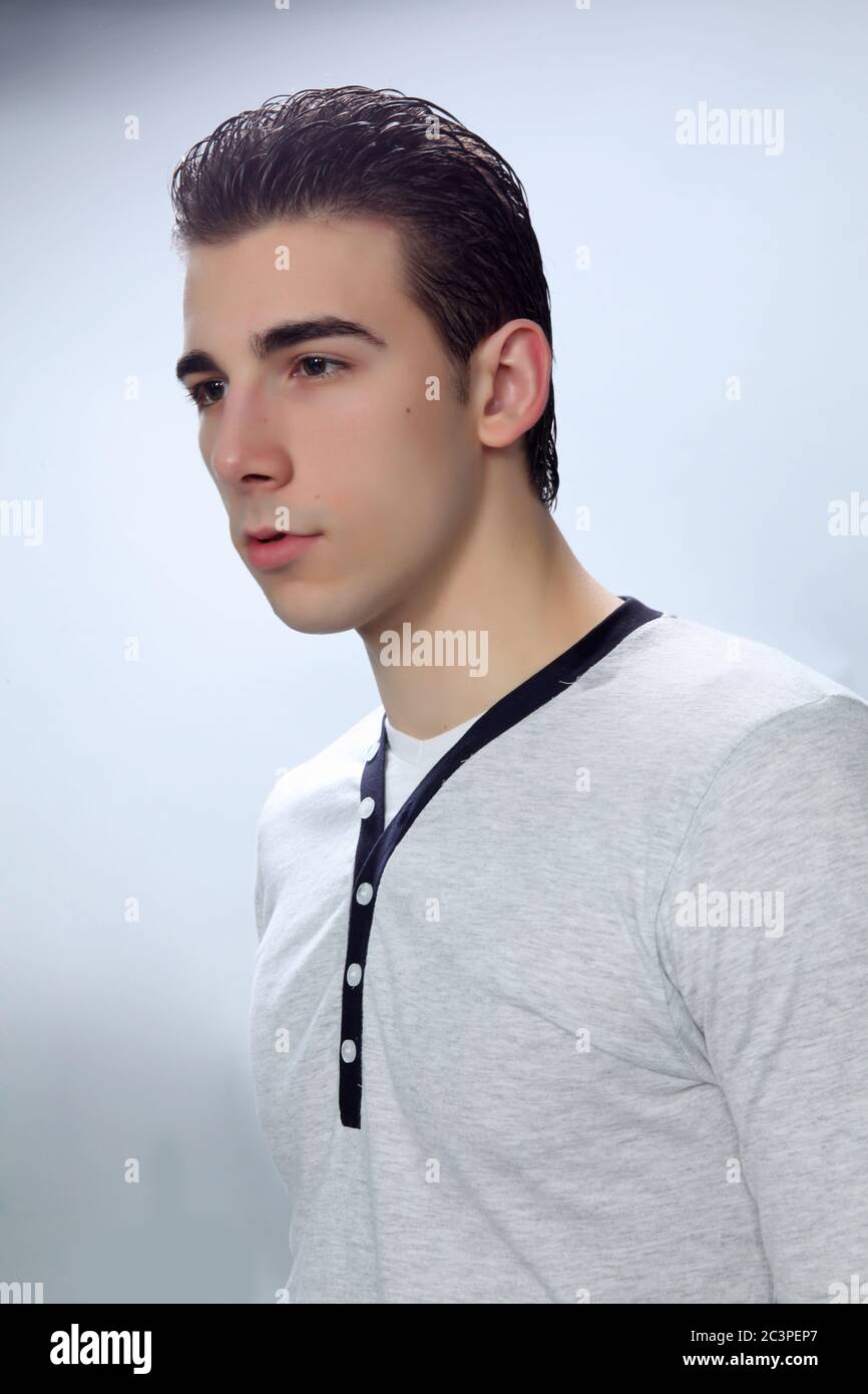 Attractive male model with short hair posing in studio on isolated ...