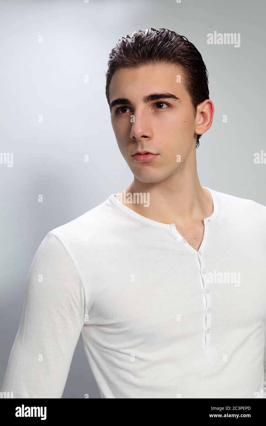 Attractive male model with short hair posing in studio on isolated ...