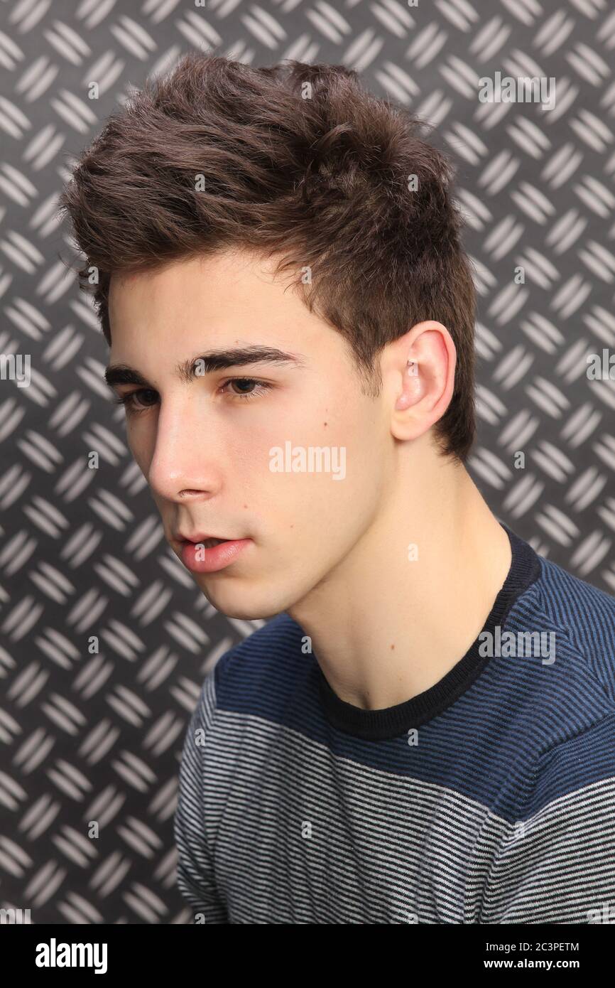 Attractive male model with short hair posing in studio on isolated ...