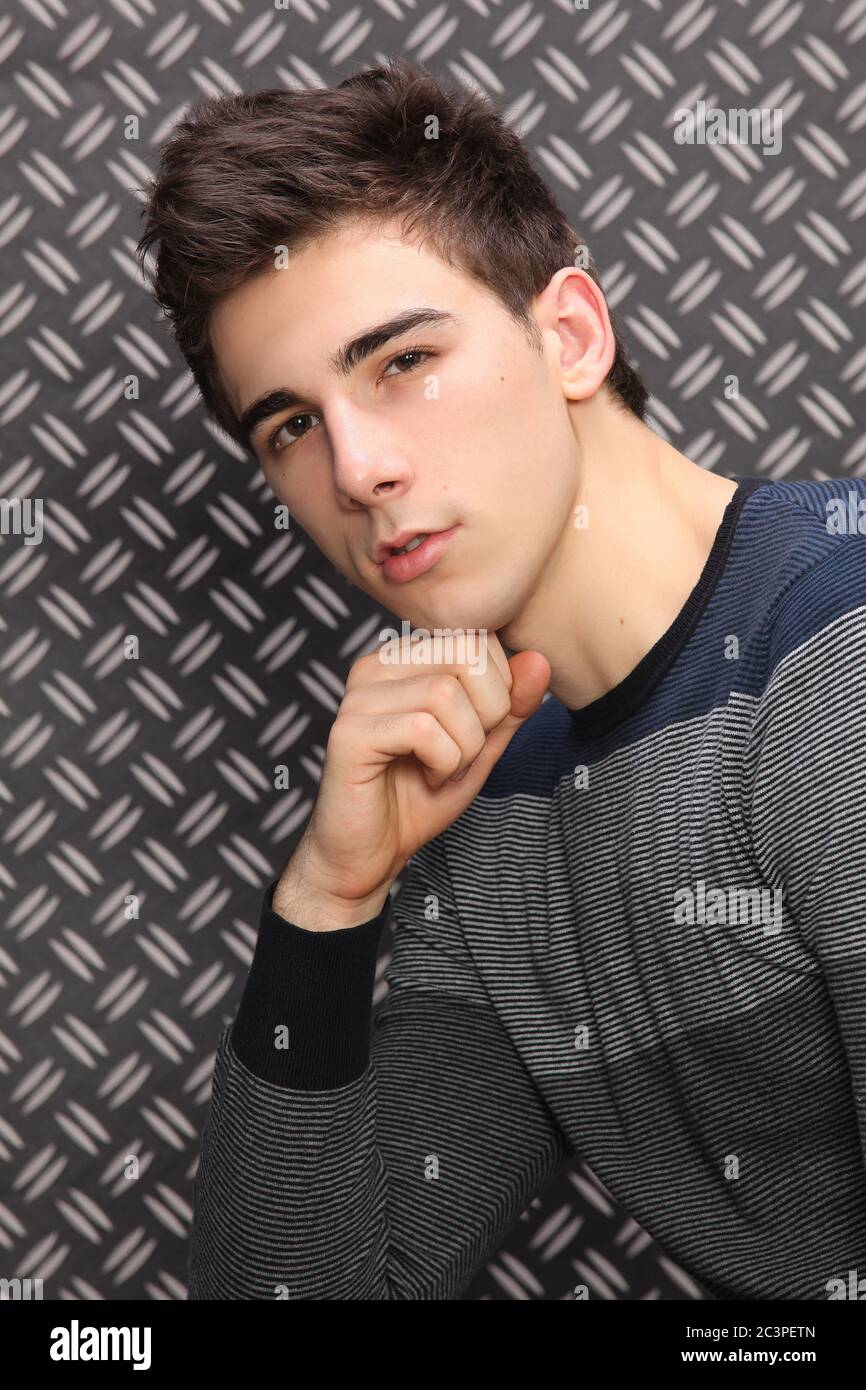 Attractive male model with short hair posing in studio on isolated ...