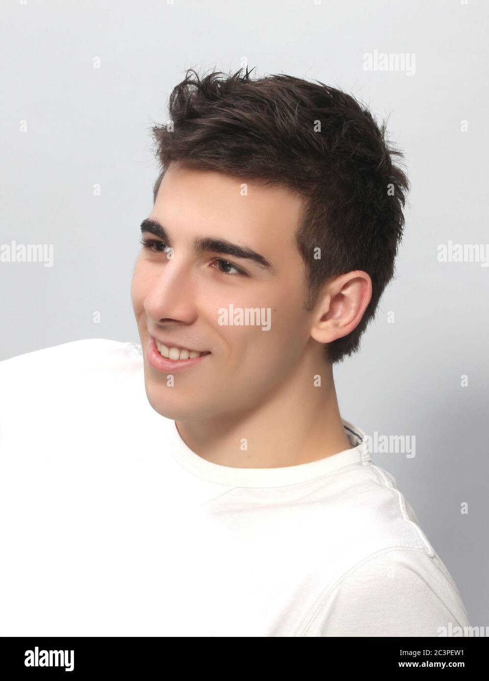 Attractive male model with short hair posing in studio on isolated ...