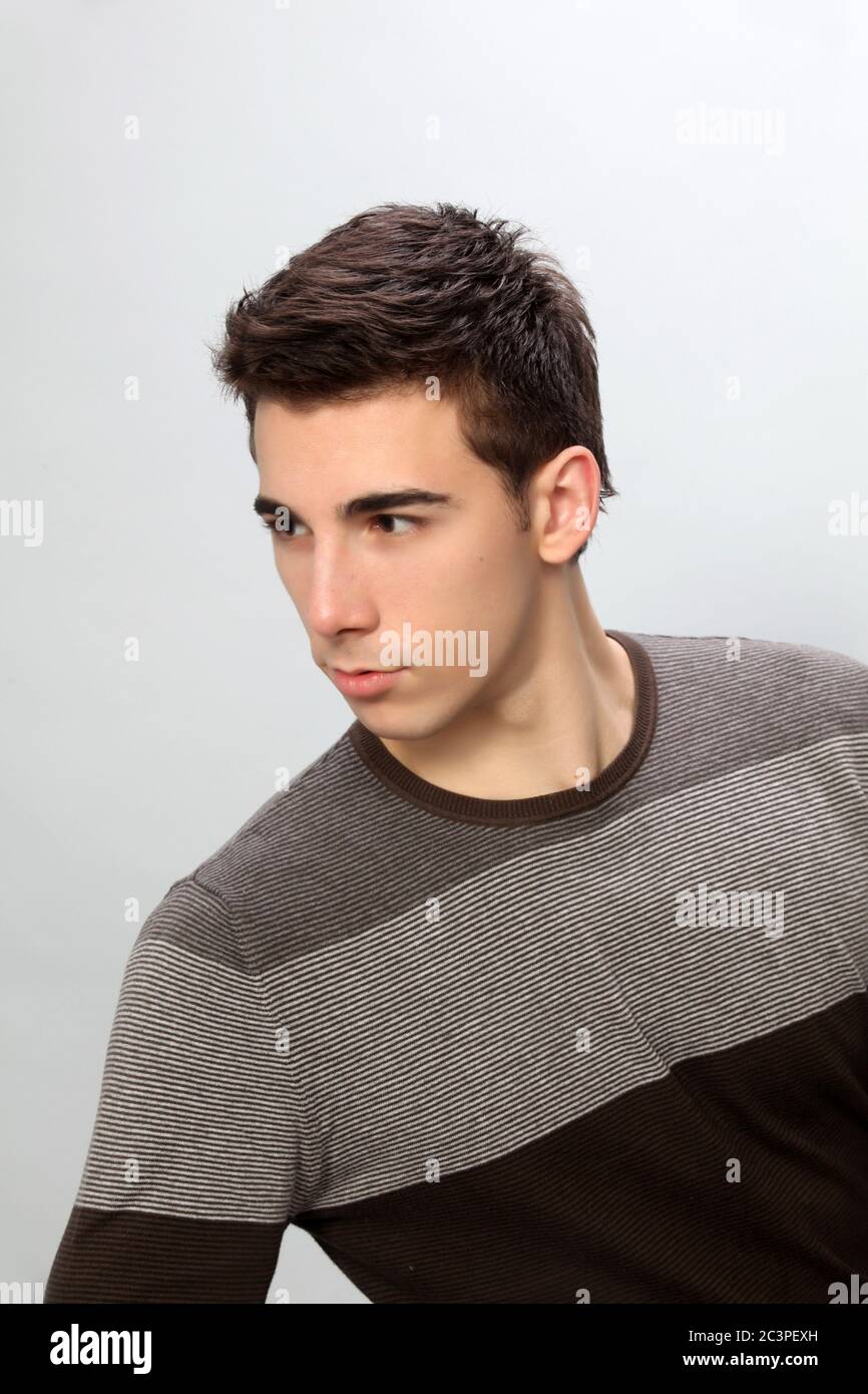 Attractive male model with short hair posing in studio on isolated ...