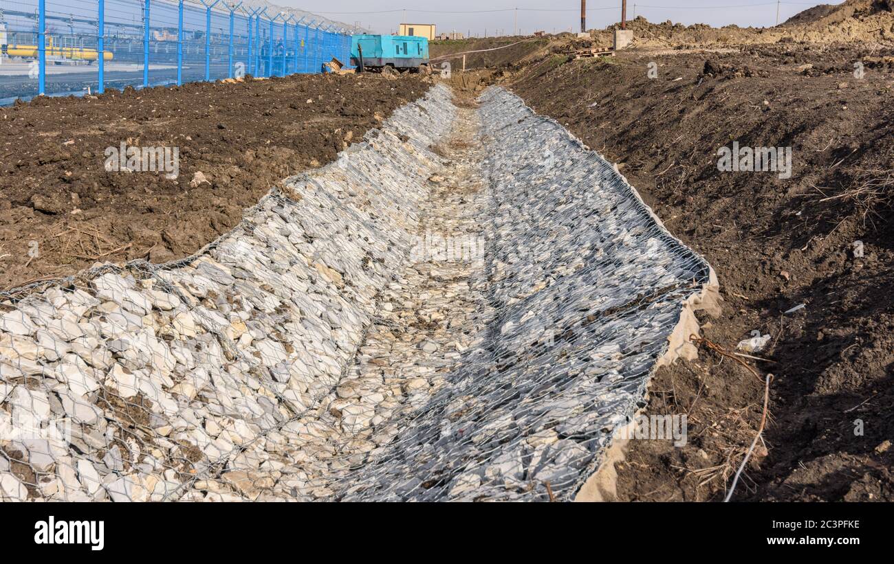 Gabion and gutter construction along the road Stock Photo - Alamy