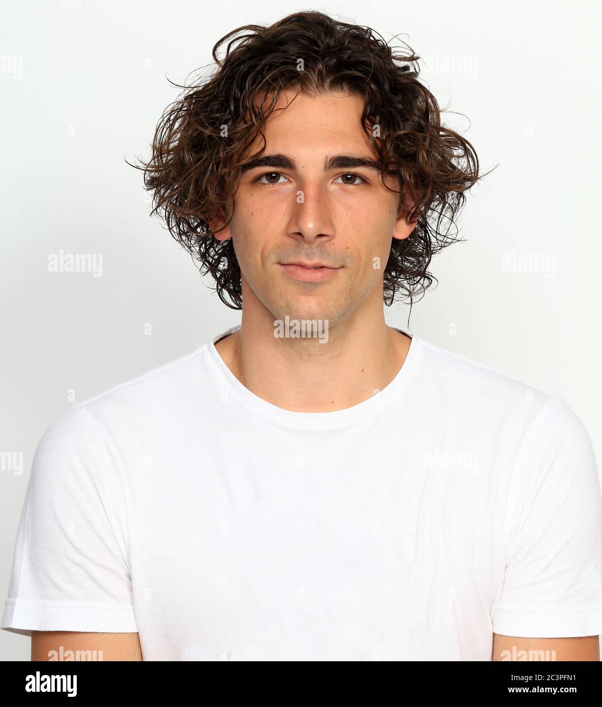 Attractive male model with short hair posing in studio on isolated ...