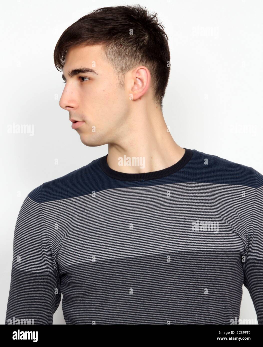 Attractive male model with short hair posing in studio on isolated ...
