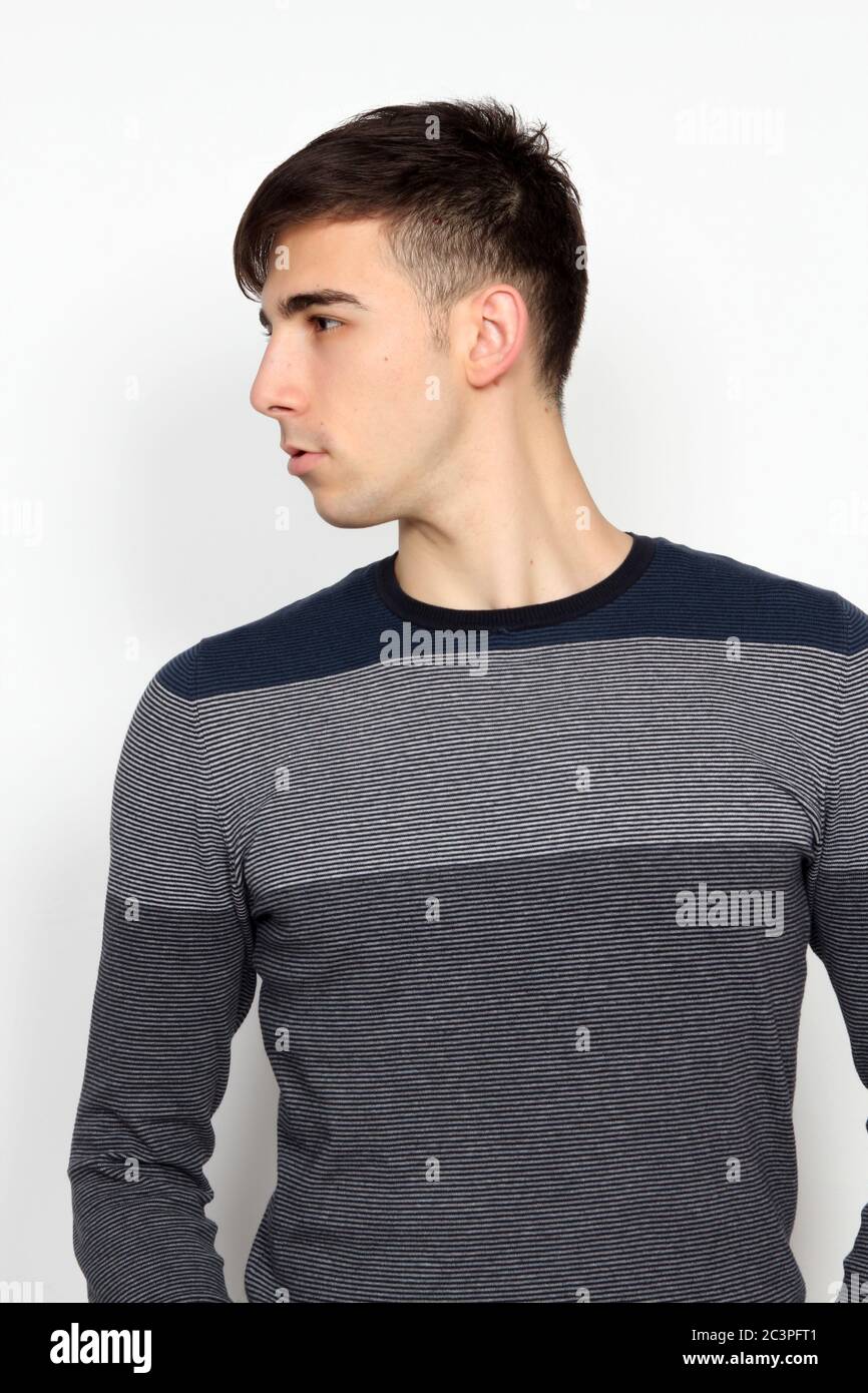 Attractive male model with short hair posing in studio on isolated ...